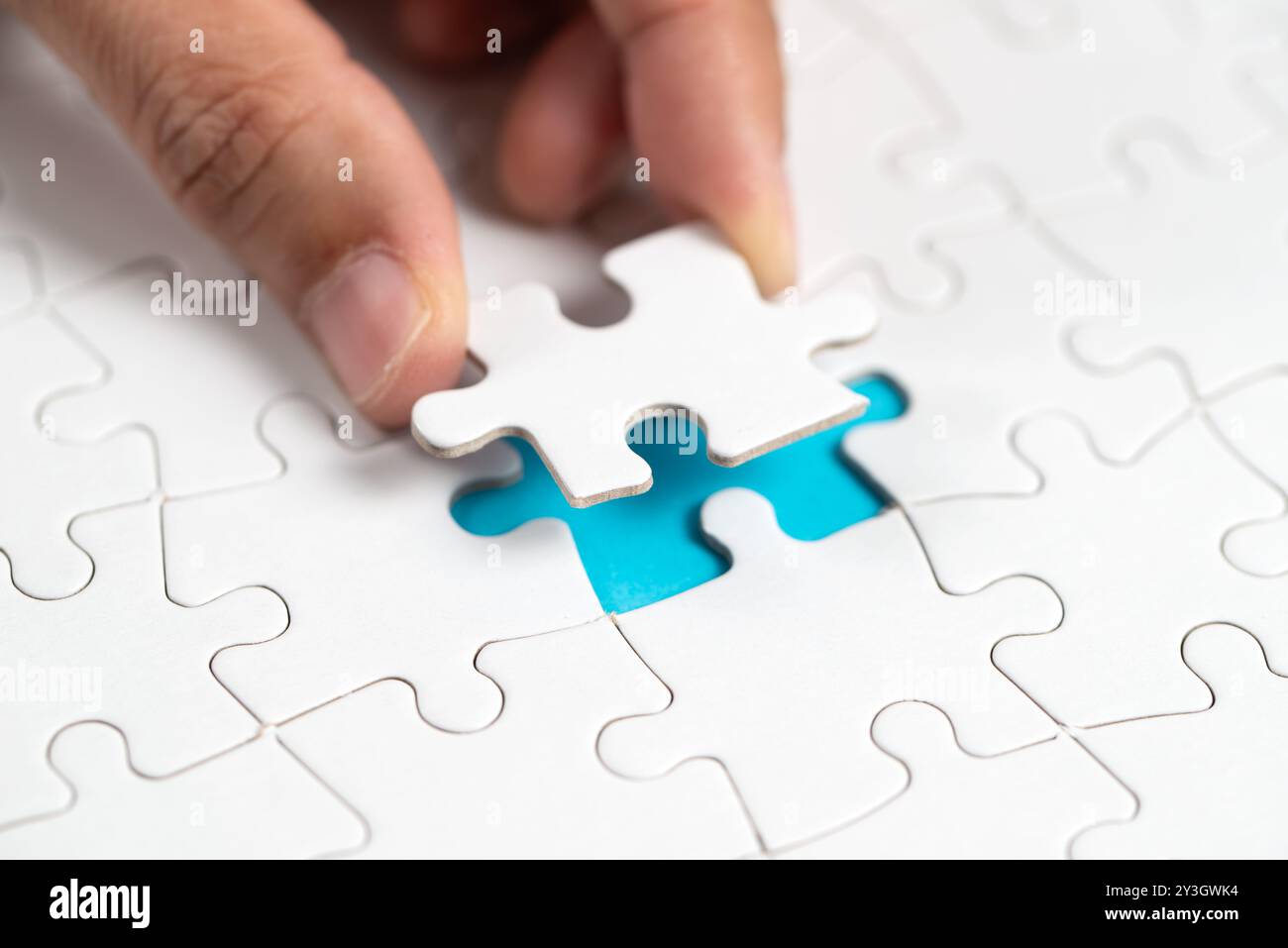 Hand put the last piece of jigsaw puzzle to complete the mission Stock ...