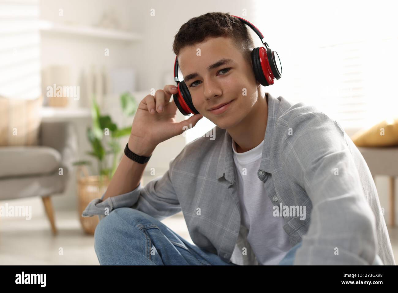 Portrait of teenage boy listening to music at home Stock Photo - Alamy