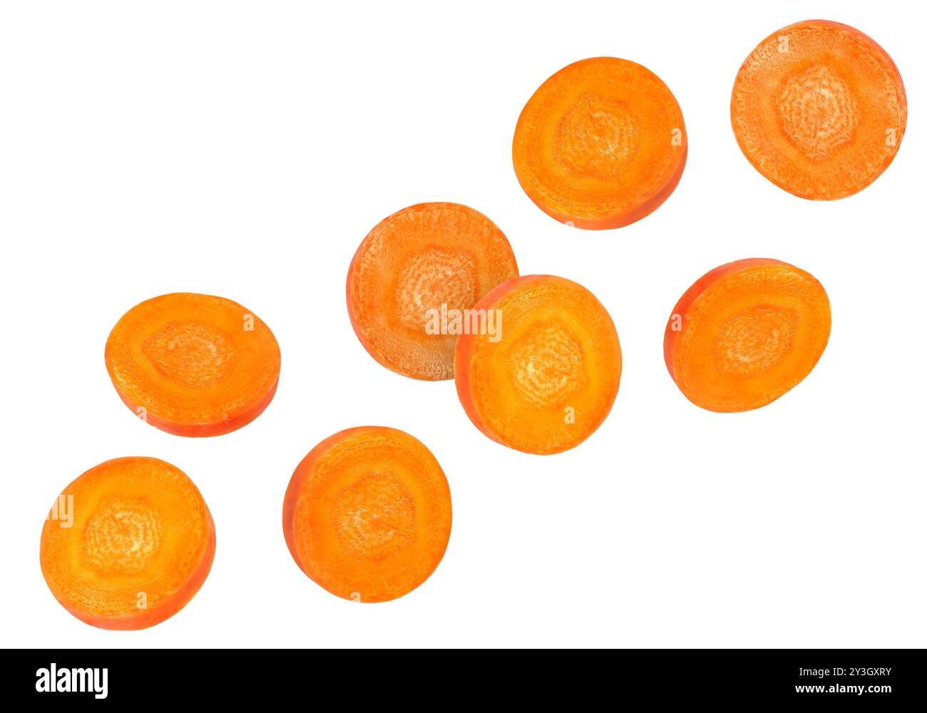 Round carrot slices in air on white background Stock Photo - Alamy