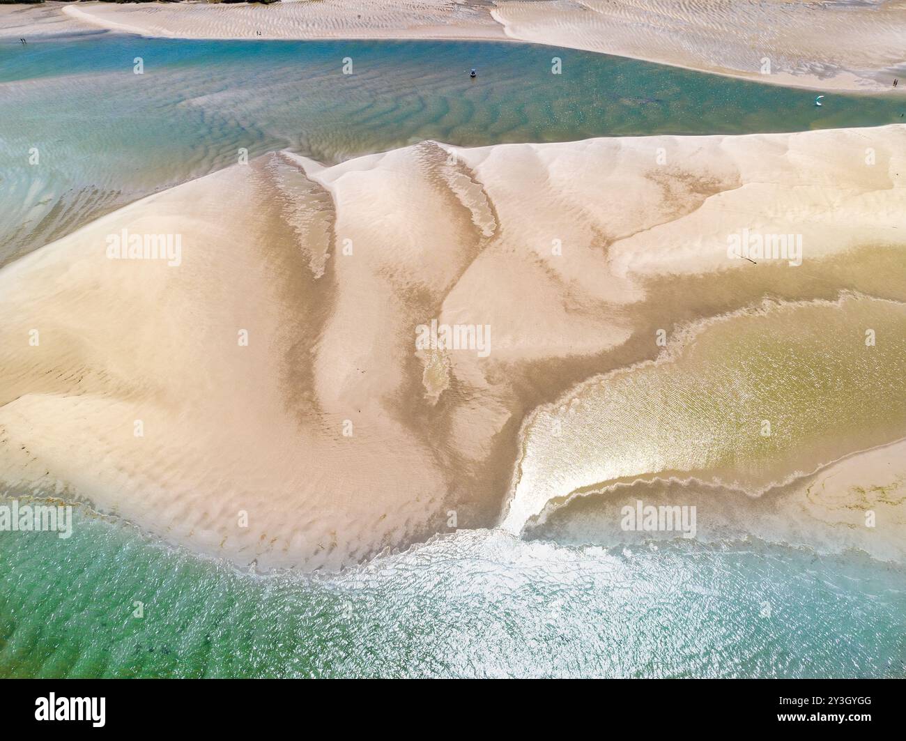 Aerial view of sand flats and water channels during low tide at Golden ...