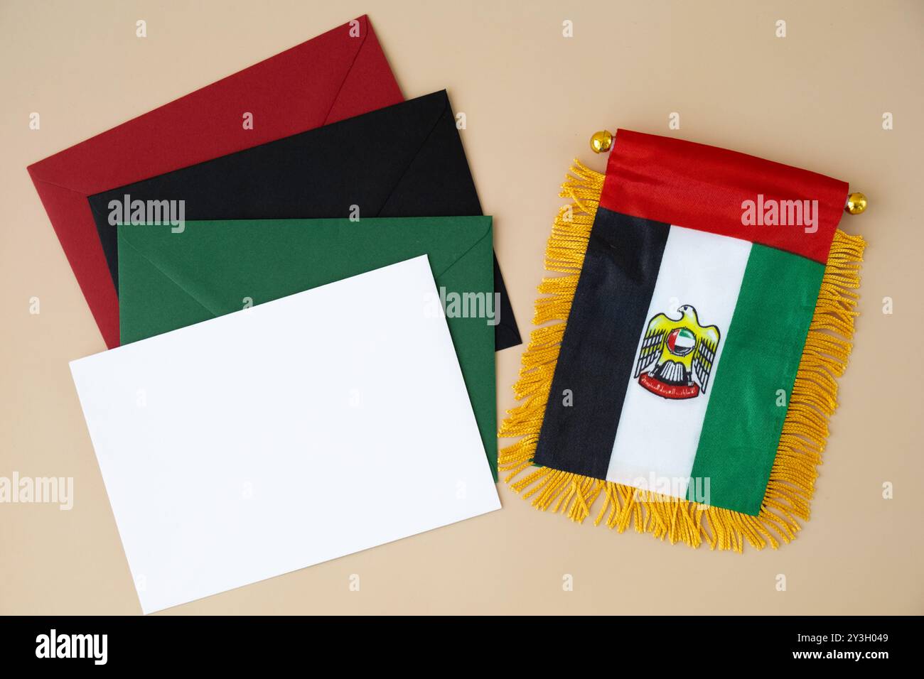 Small flag of UAE on beige background with colorful envelopes. Copy ...