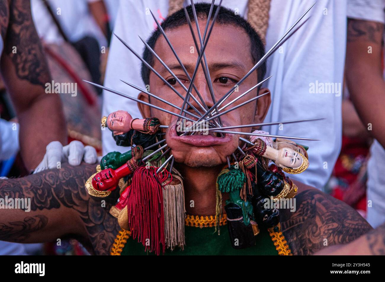 Ma-Thong (spirit medium) in trance w/ cheeks pierced with long needles ...