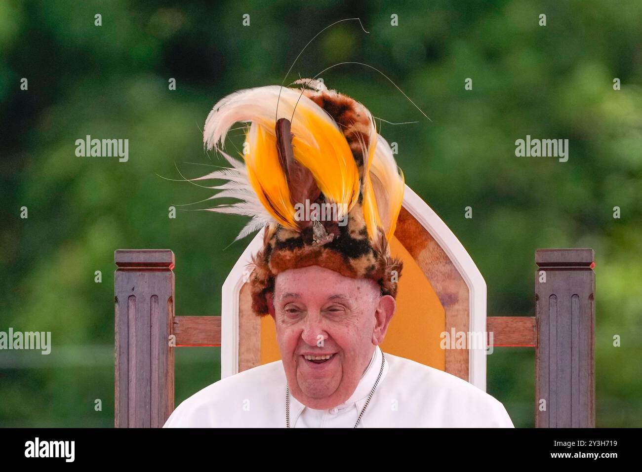 Pope Francis wears a traditional hat during a meeting with faithful in ...