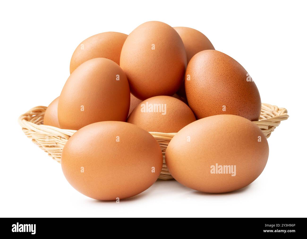 Group of fresh brown chicken eggs in stack in wicker basket is isolated ...