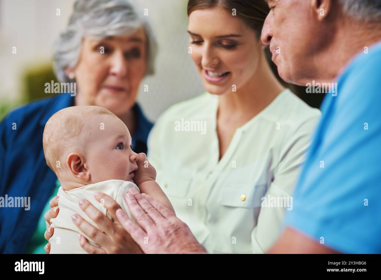 Mother, baby and grandparents relax in nature, support and love in ...