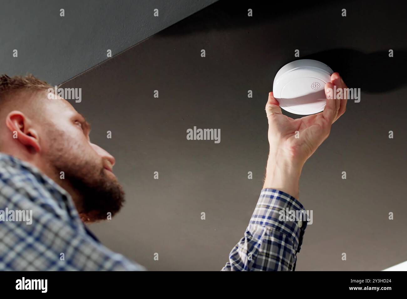 Removing Smoke Detector From Ceiling At Home Stock Photo - Alamy