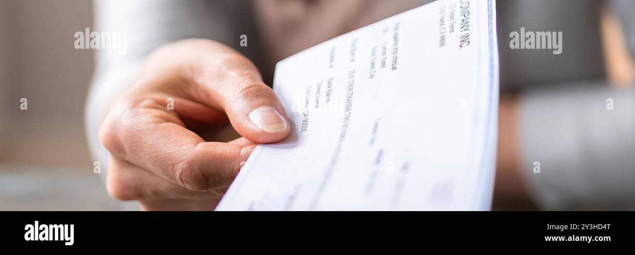 Hand giving paycheck, check, cheque in transaction concept Stock Photo ...