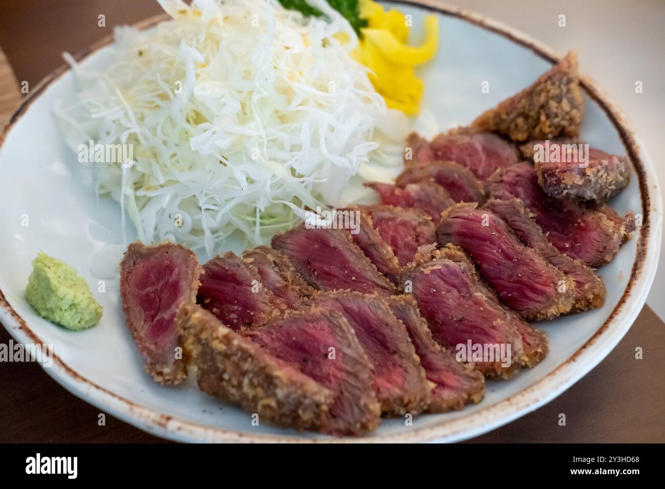 Set of Gyukatsu or beef cutlet served with cabbage. A traditional ...