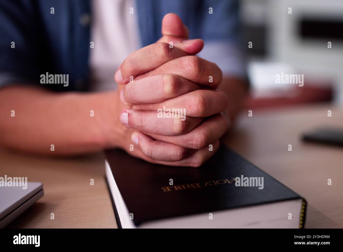 Christian Man Hand Praying With Bible Book Stock Photo - Alamy