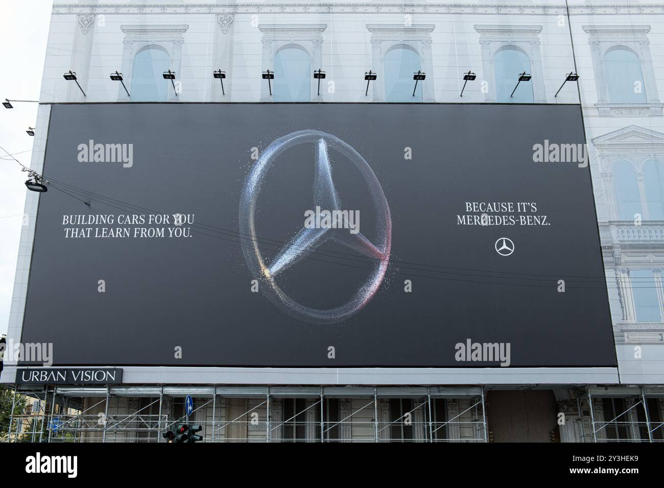 Mercedes Benz advertising billboard on the facade of a building during ...