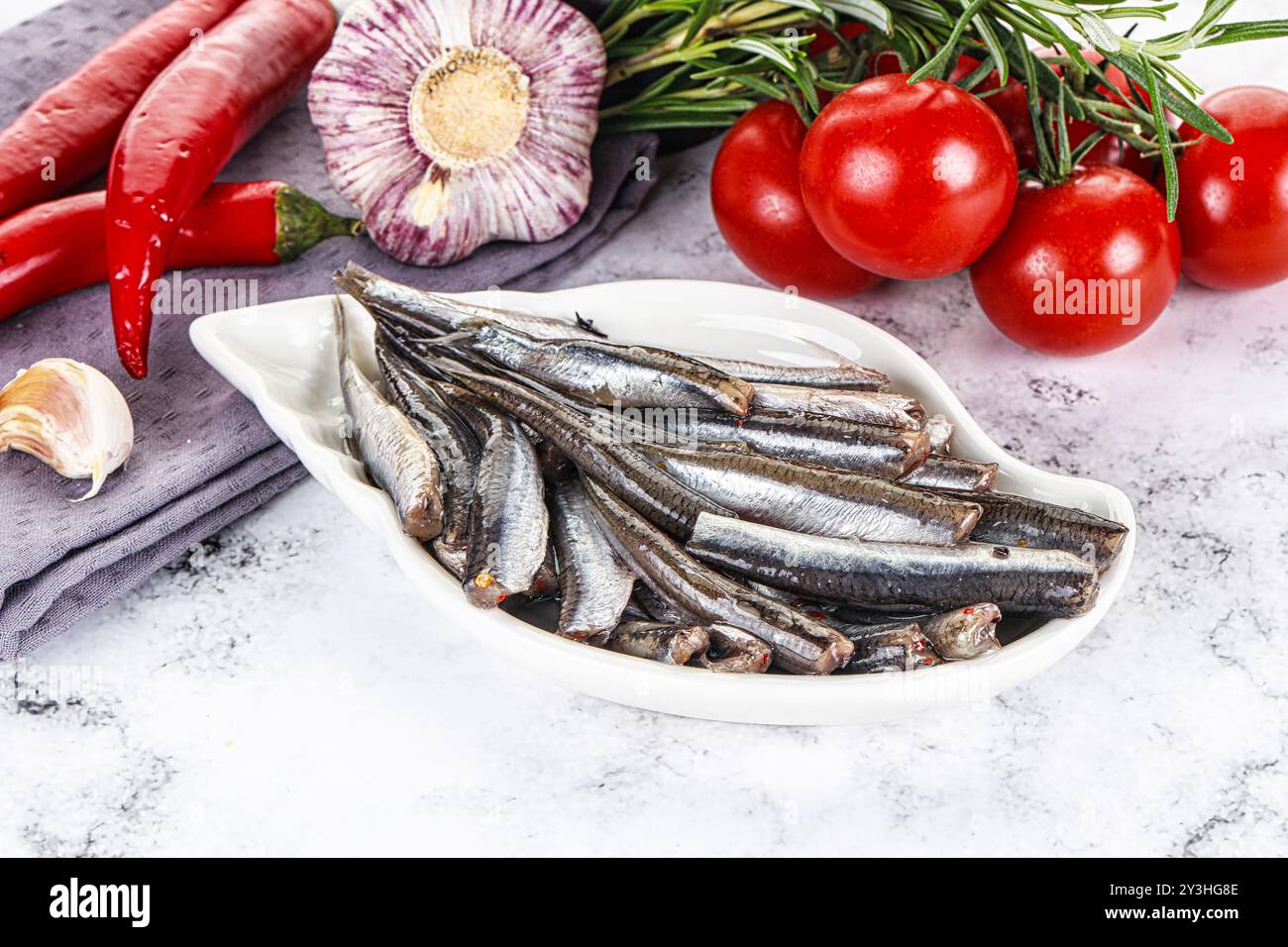 Pickled anchovy fish in the plate Stock Photo - Alamy