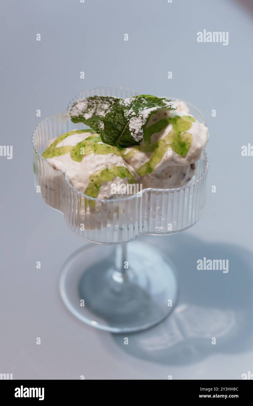 Elegant Dessert Presentation with Whipped Cream, Mint Leaf, and Green ...