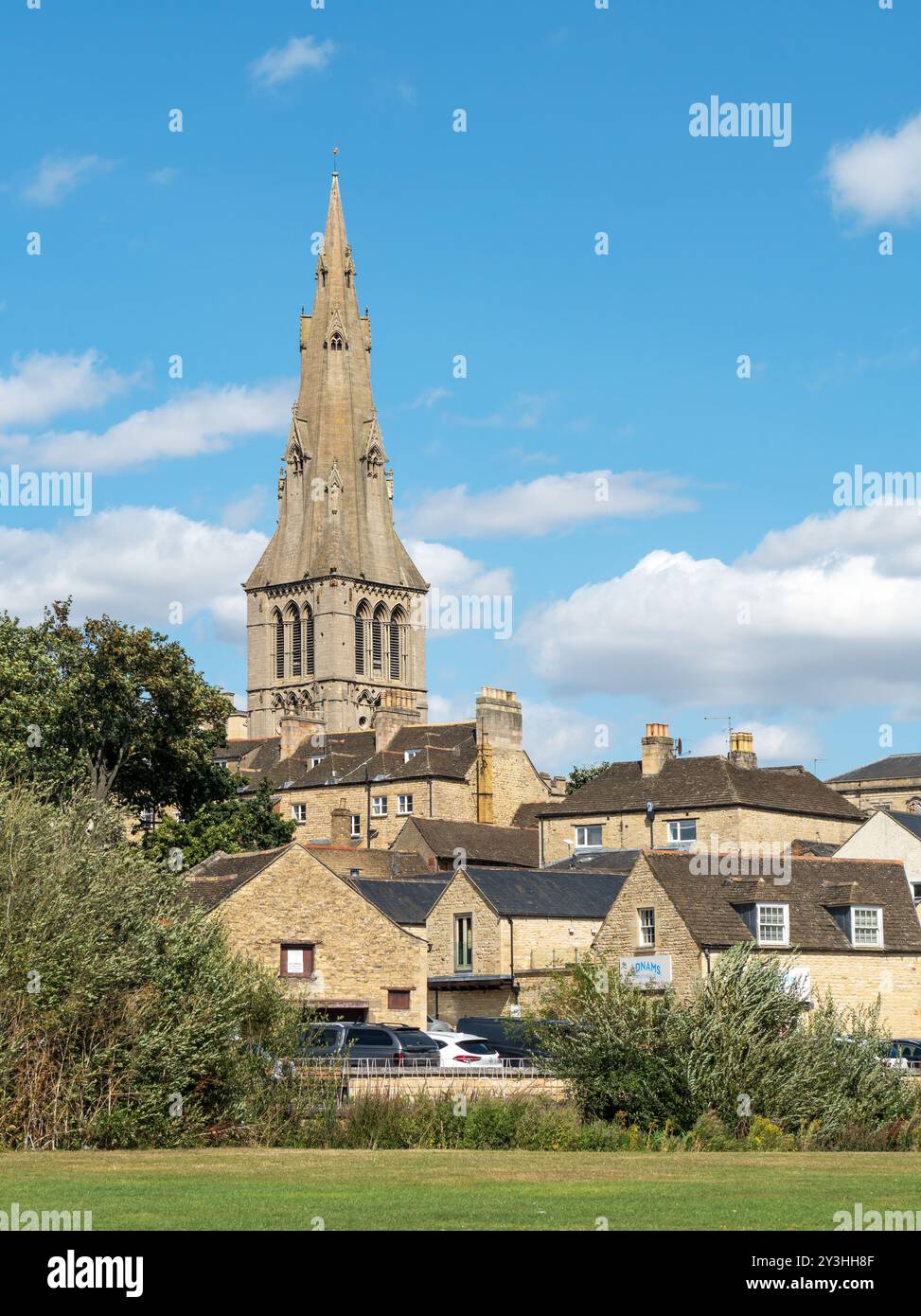 St. Mary's Church spire / tower above stone building rooftops in August ...
