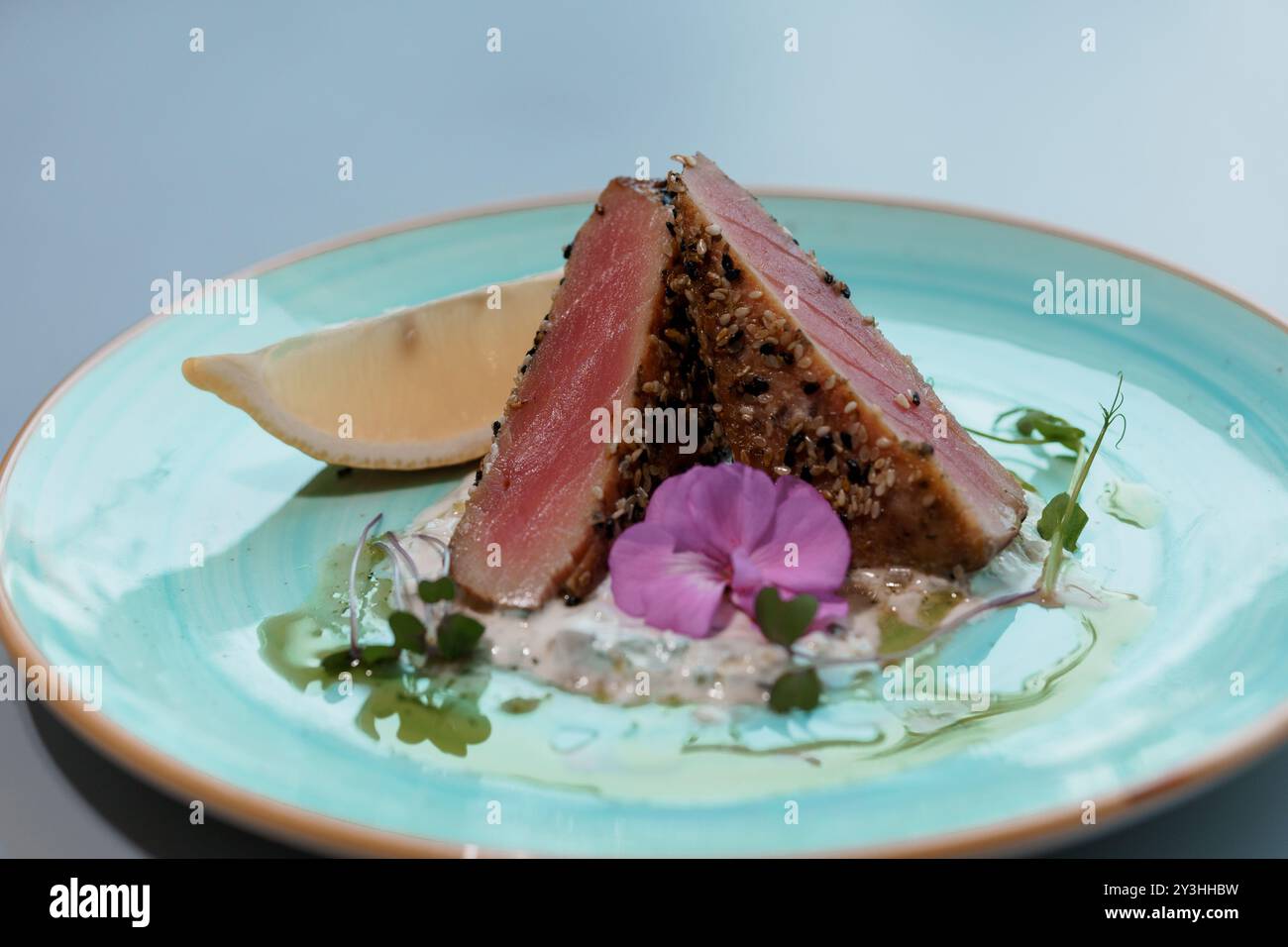 Gourmet Seared Tuna with Black Sesame Crust on Elegant Plate with Lemon ...