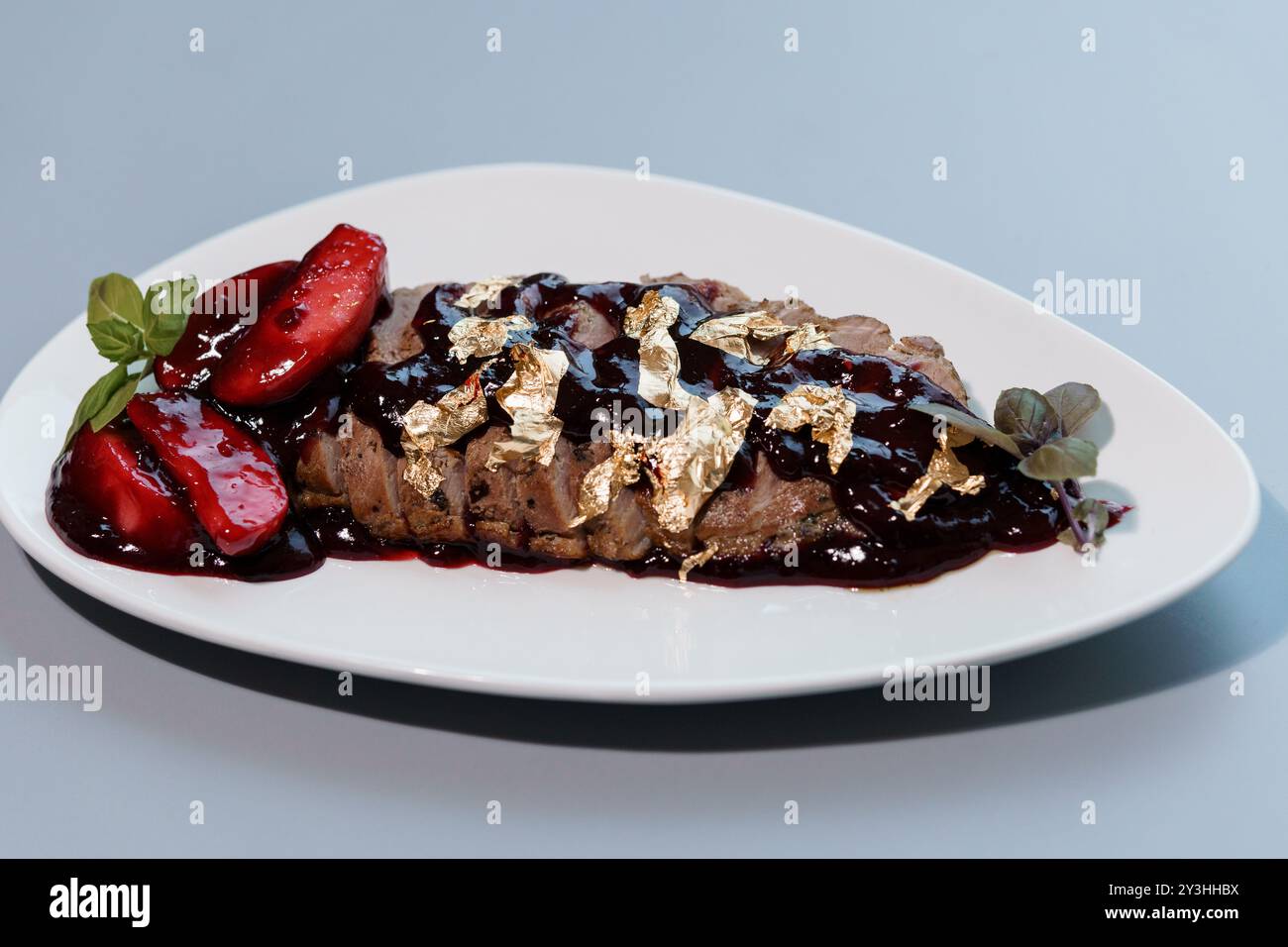 Gourmet Beef Steak with Gold Leaf and Berry Sauce on Elegant White ...