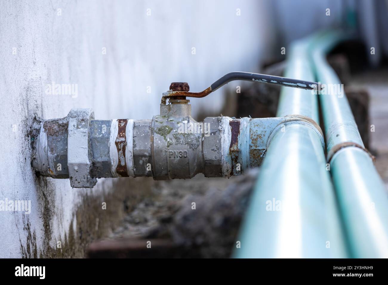 Close-up of plumbing pipe and valve on house rooftop, water system ...