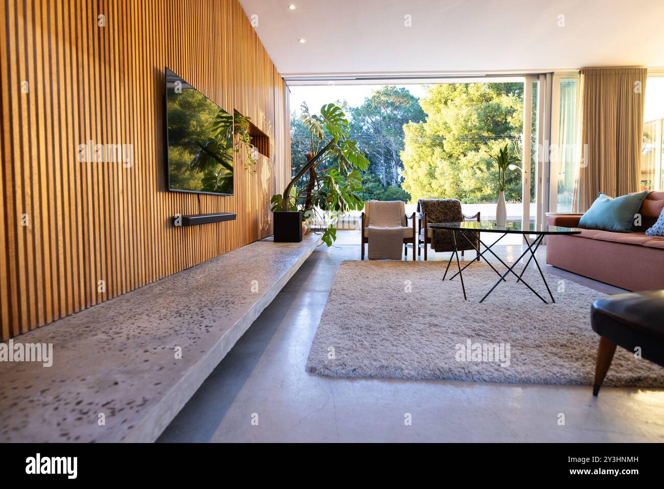 At home, Modern living room with large windows, TV, and comfortable ...