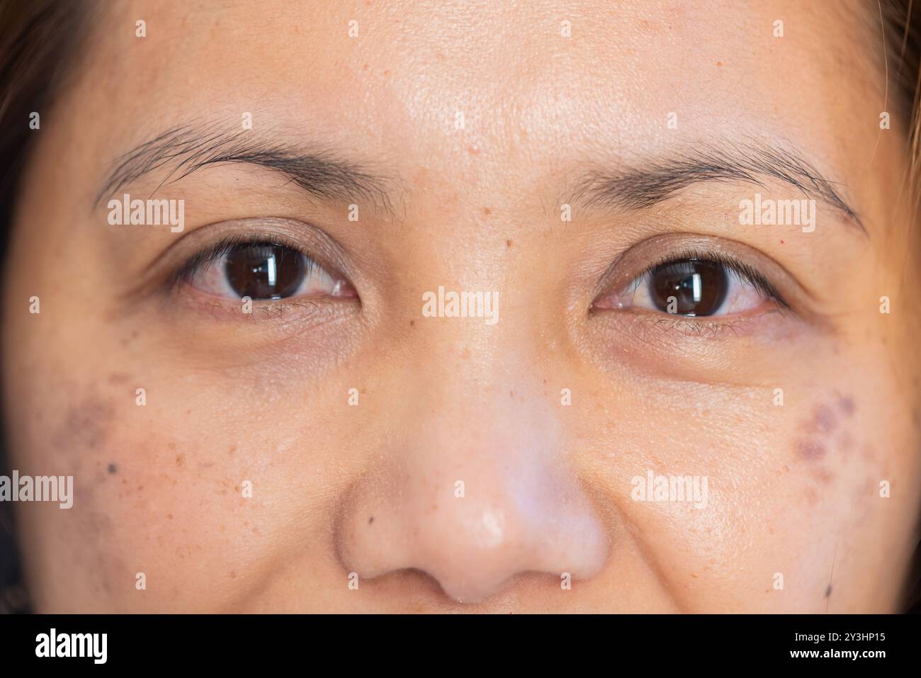 At home, Close-up of mature asian woman's face with visible skin ...