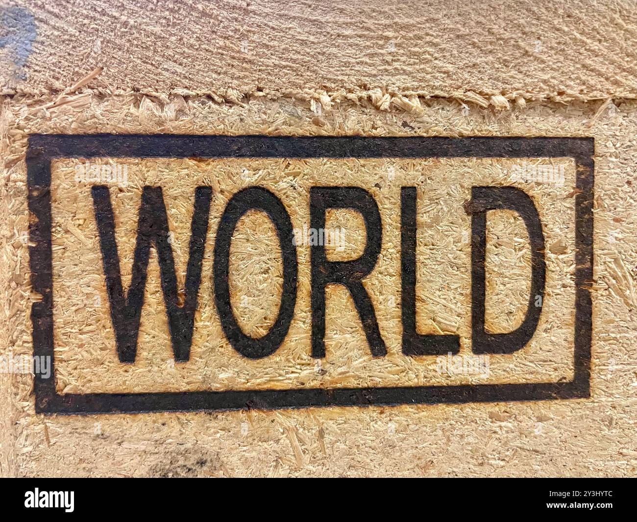 Word World burned into wood Stock Photo - Alamy