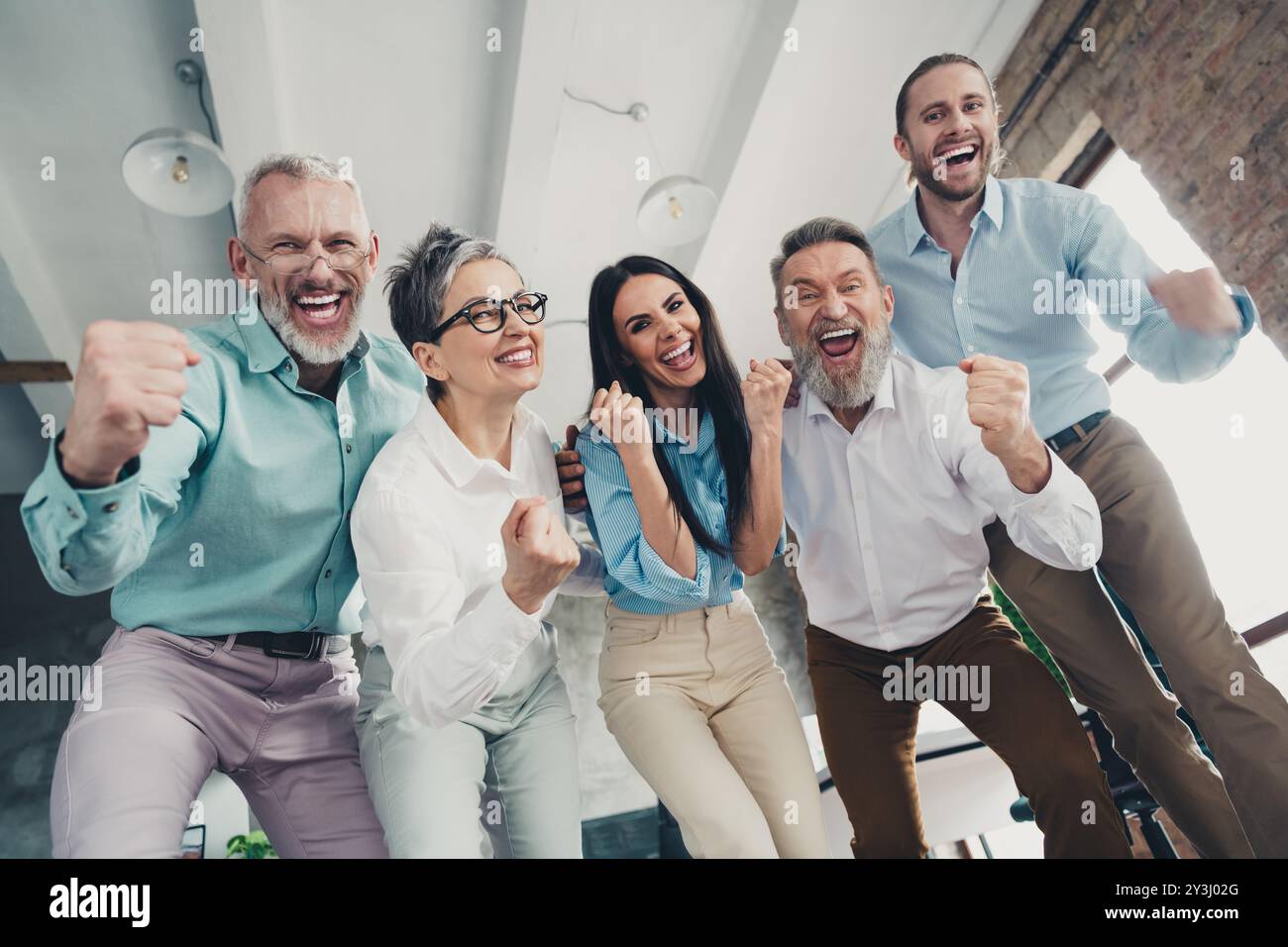 Photo low view of teamwork people working together winning raise fists ...