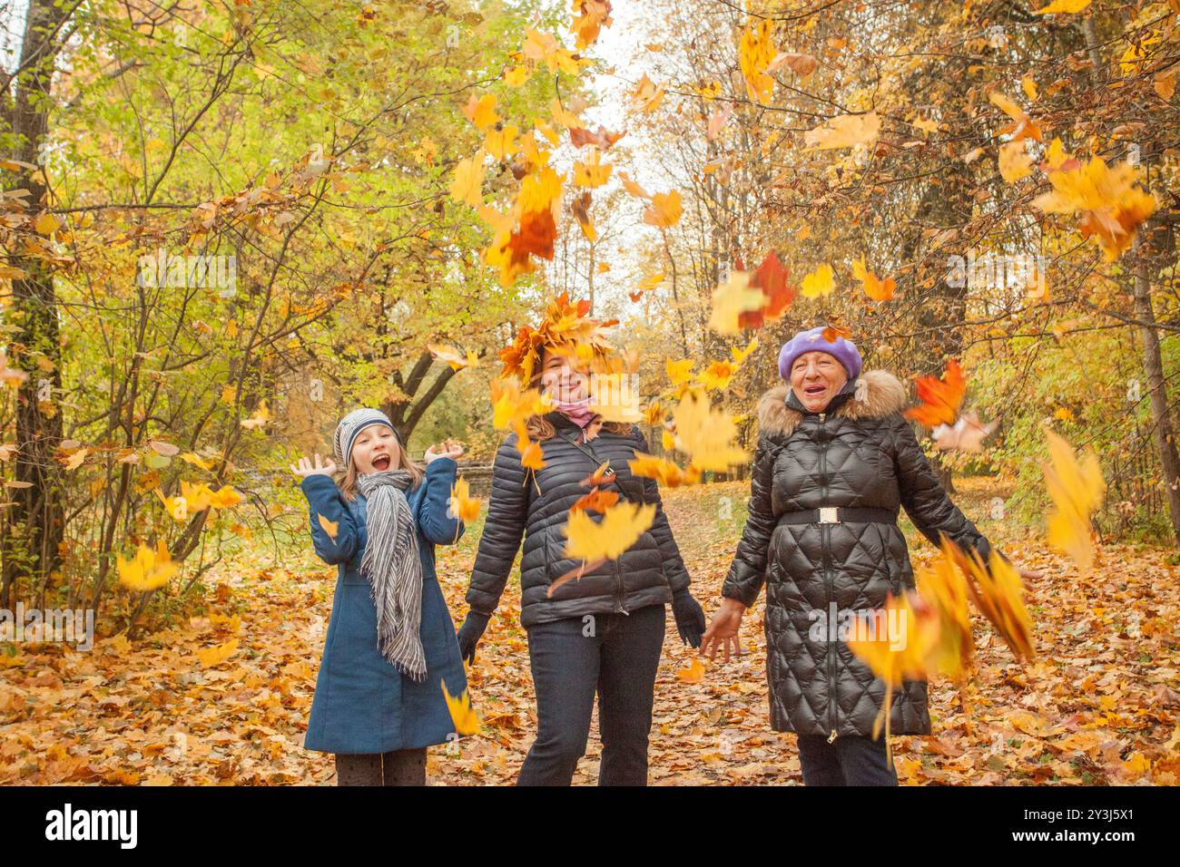Grandma, mom and daughter walking in autumn park. Happy family Stock ...