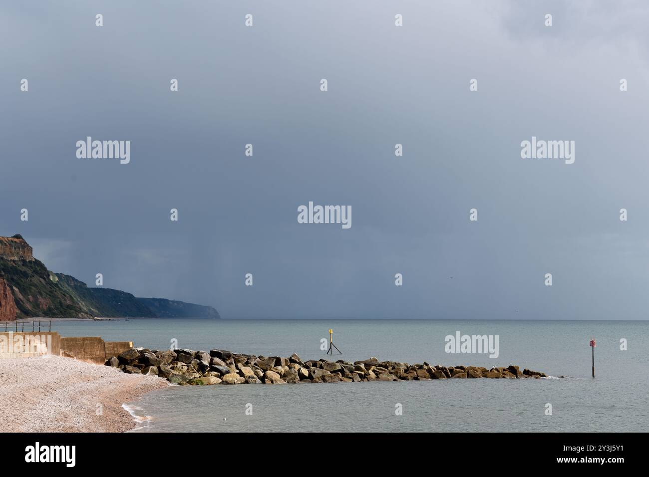 Jetty made of rocks running out into the Sea Sidmouth Devon England uk ...