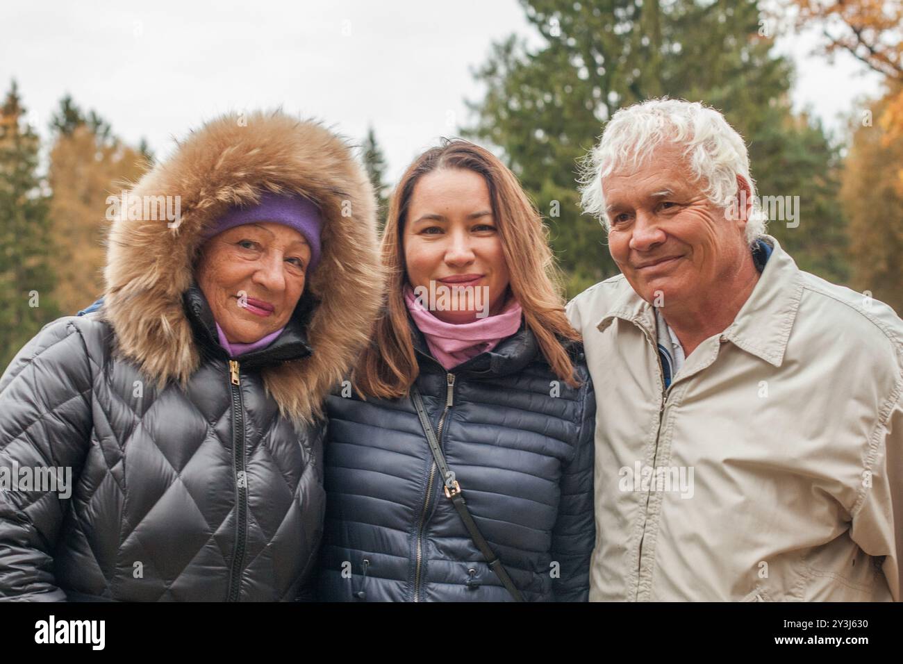 Woman hugging grandparents outdoors. Happy grandma, grandpa and ...