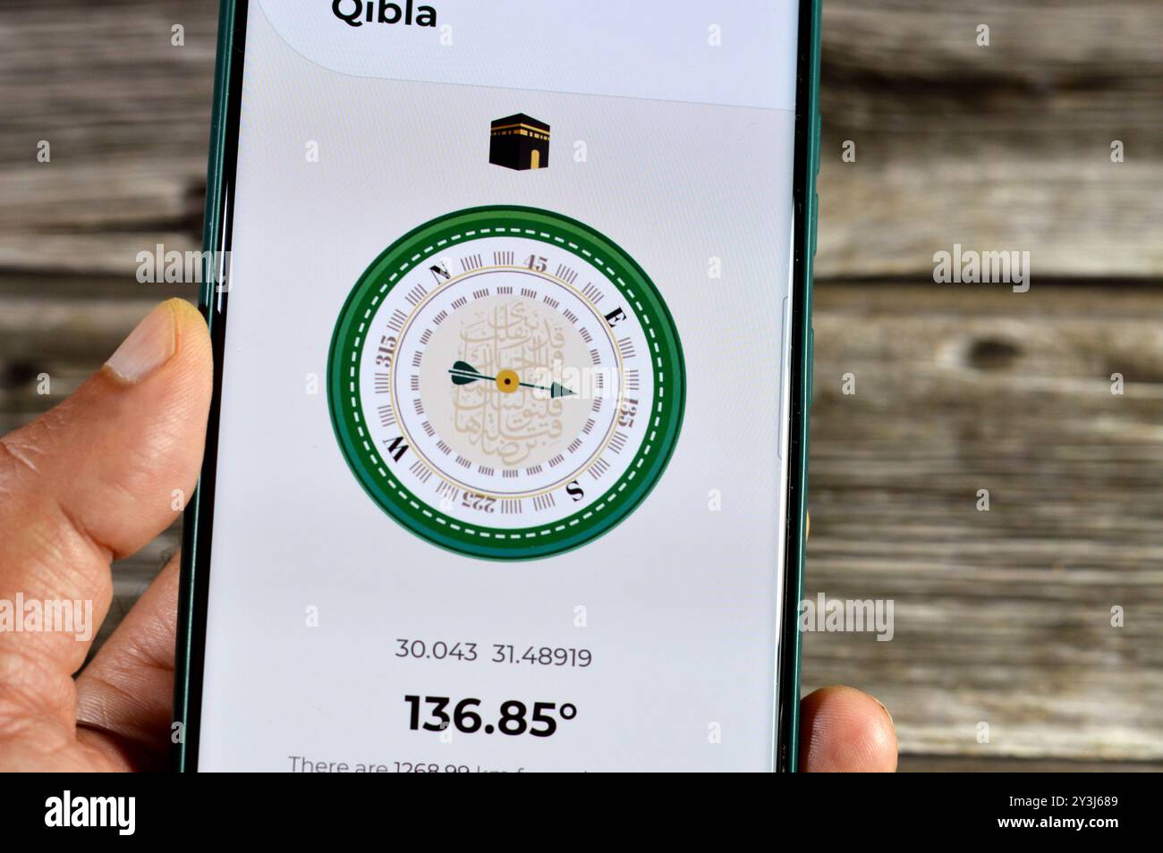 Cairo, Egypt, August 27 2024: Qibla direction towards Kaaba by a mobile smartphone application ...
