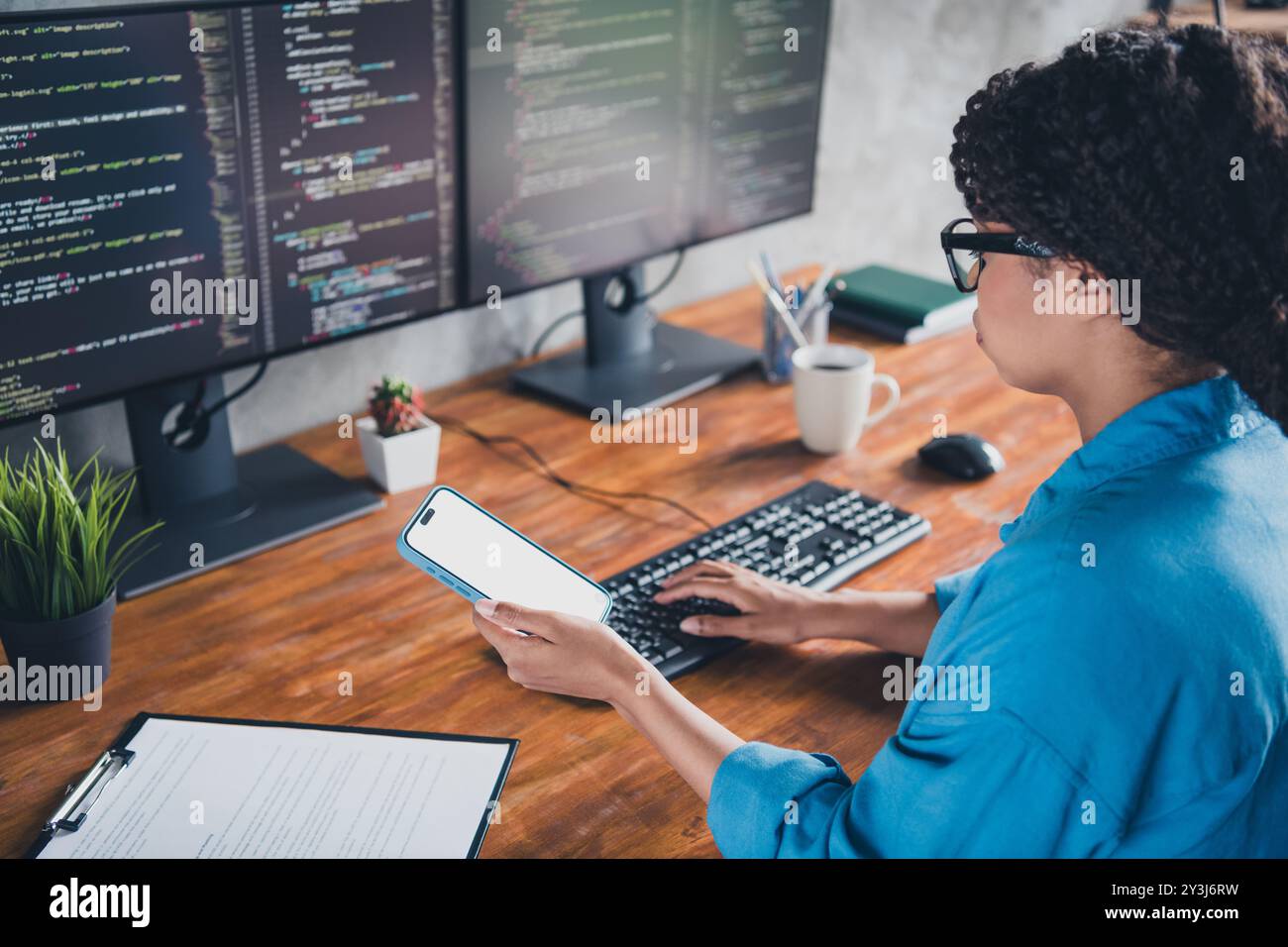 Photo of young woman typing keyboard hold device white screen wear blue ...