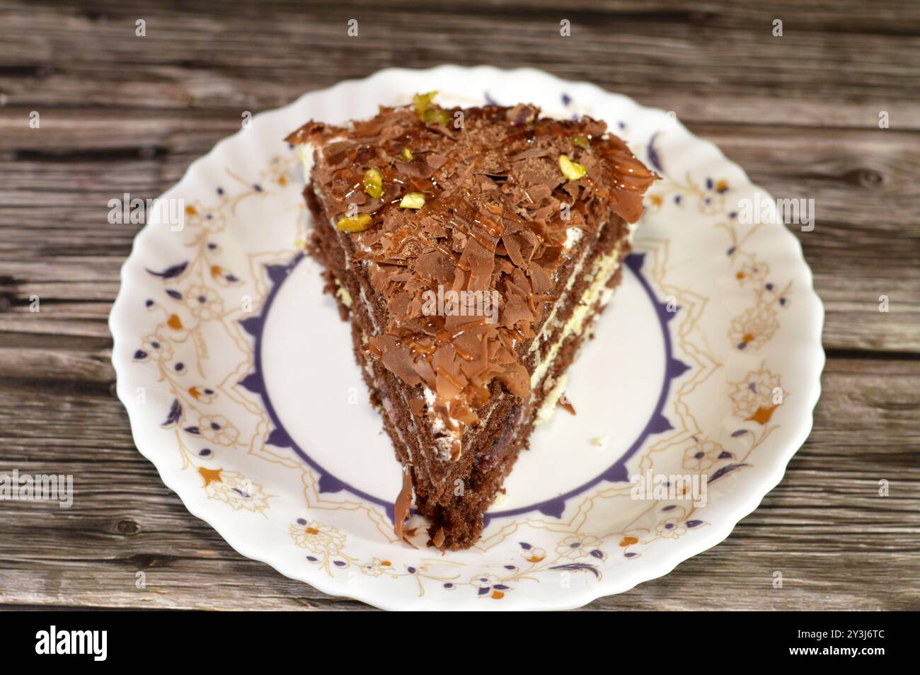 grated chocolate triangular spongy cake piece filled and topped with ...