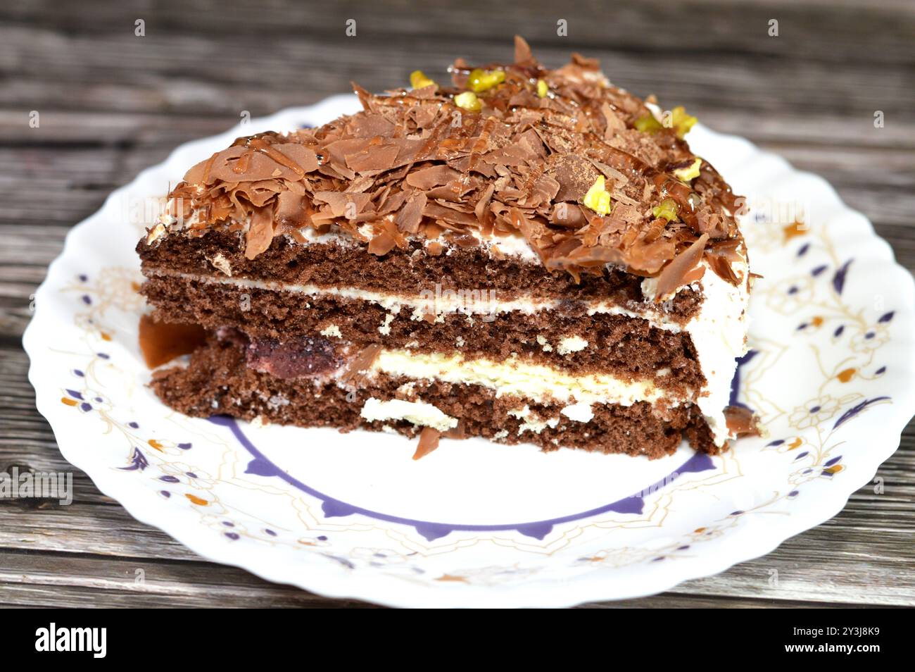 grated chocolate triangular spongy cake piece filled and topped with ...