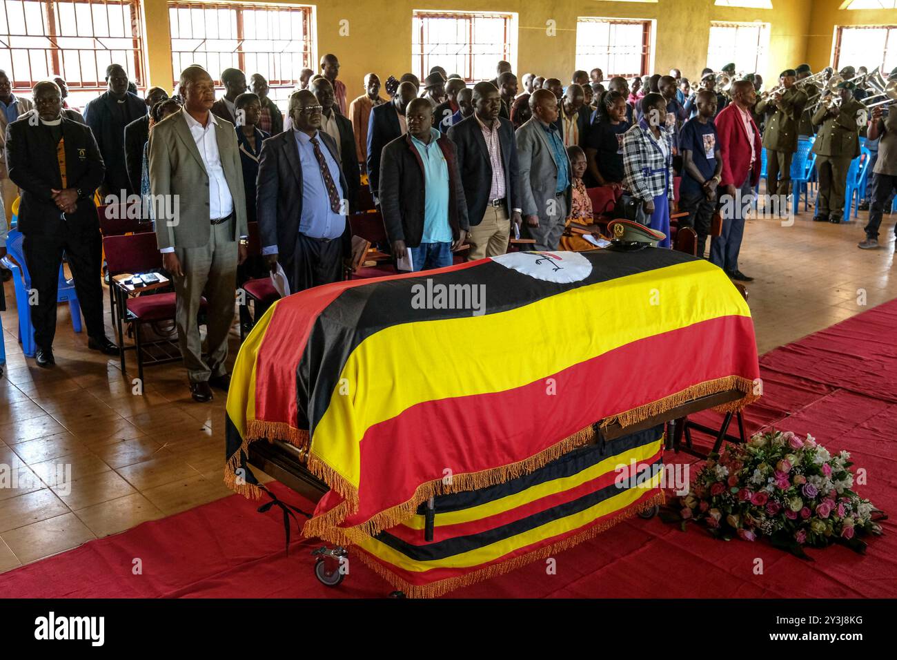 Members of the public gather for a funeral service of Ugandan Olympic ...