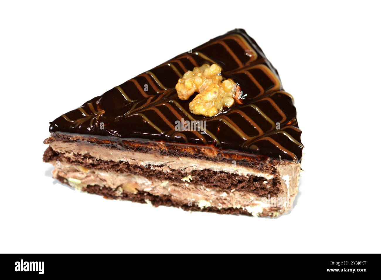 chocolate triangular spongy cake piece filled and topped with walnut ...