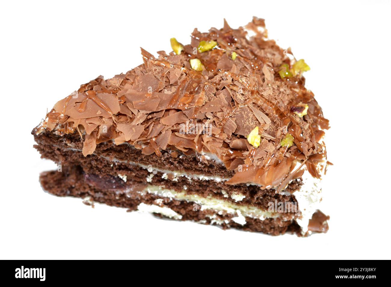 grated chocolate triangular spongy cake piece filled and topped with ...