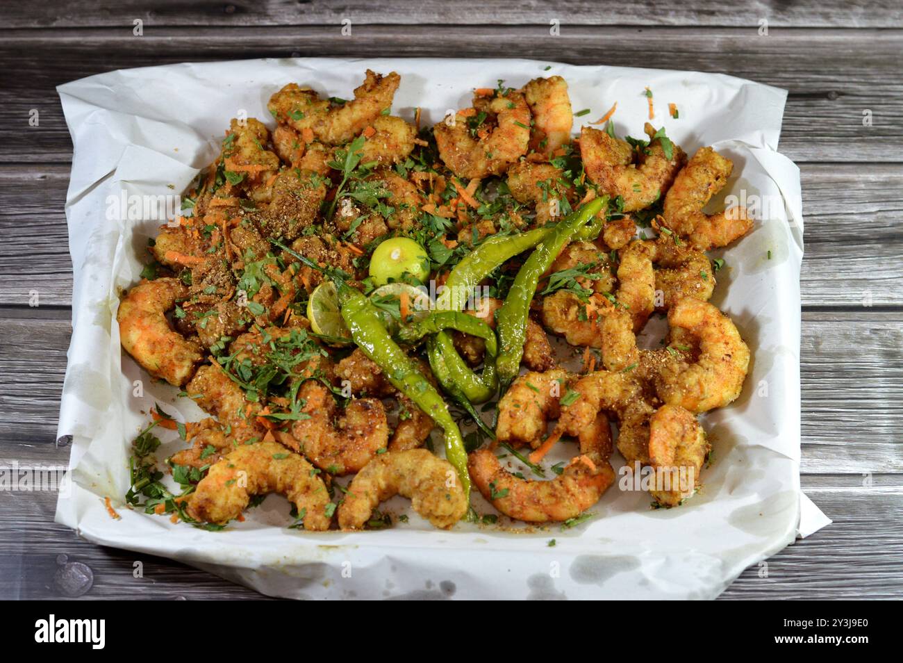 Fried shrimps with parsley, fried green chili pepper and lemon, crunchy ...