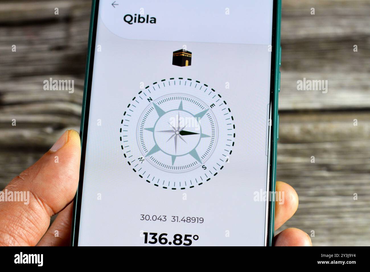 Cairo, Egypt, August 27 2024: Qibla direction towards Kaaba by a mobile smartphone application ...