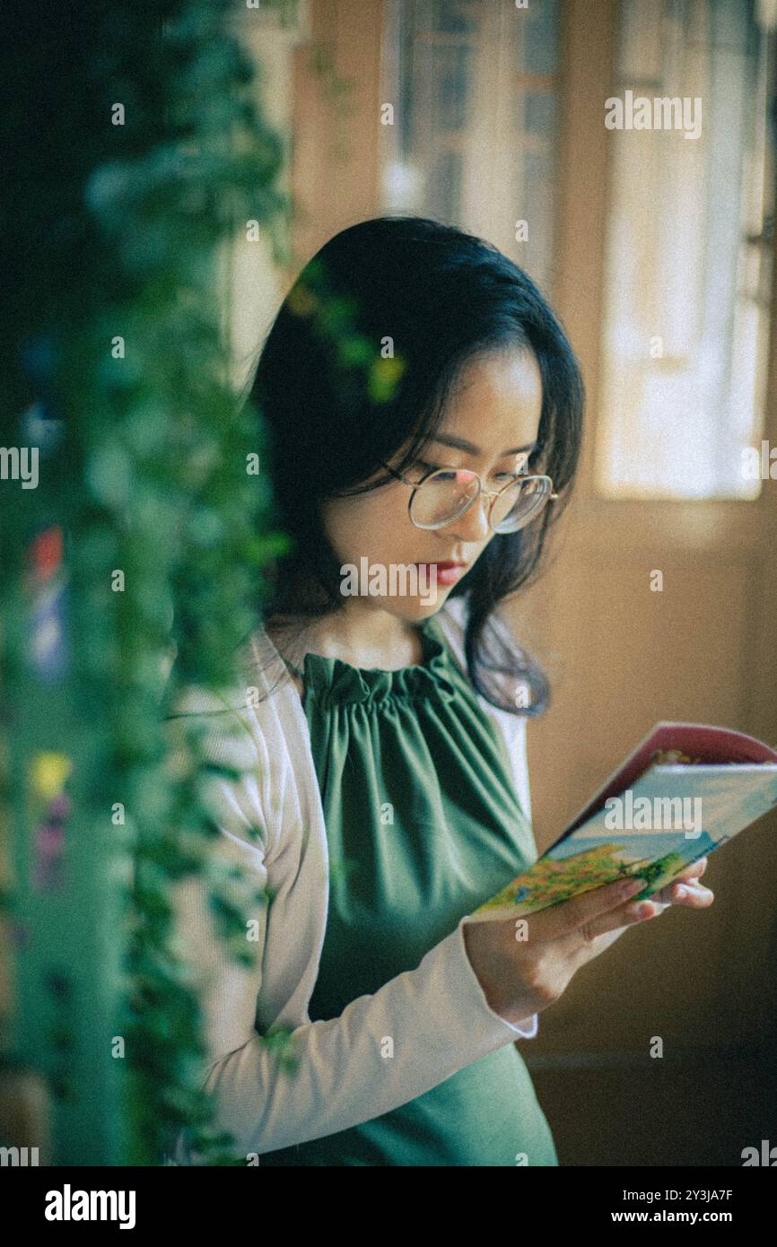 A lovely girl in a bookstore Stock Photo - Alamy