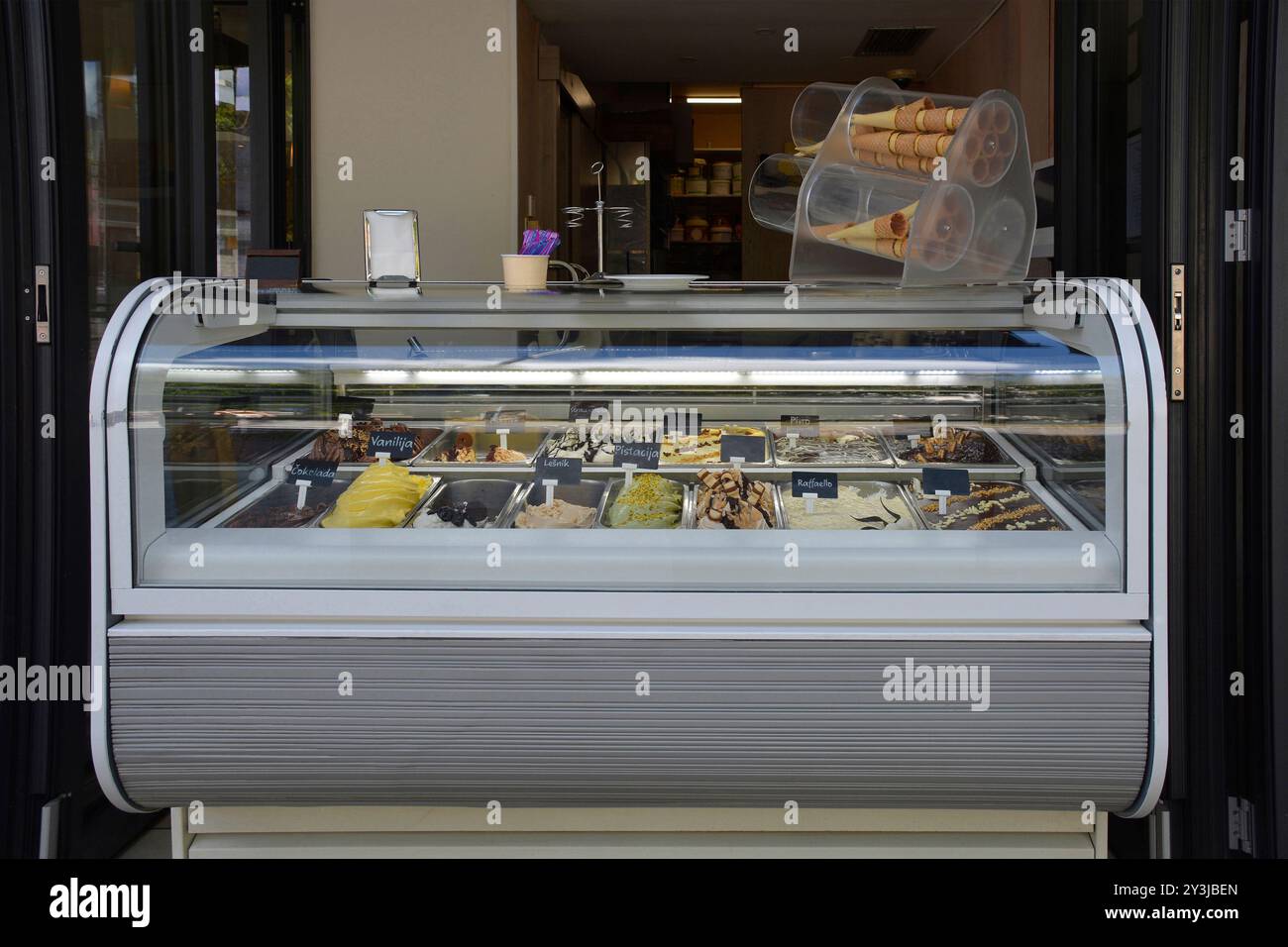 A modern ice cream parlour display case with a variety of colourful ice ...