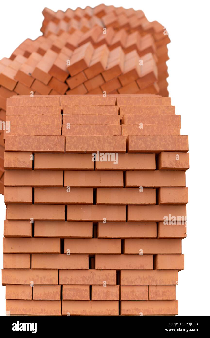 Stacks of new, red ceramic brick stacked on wooden pallets. Lots of new ...