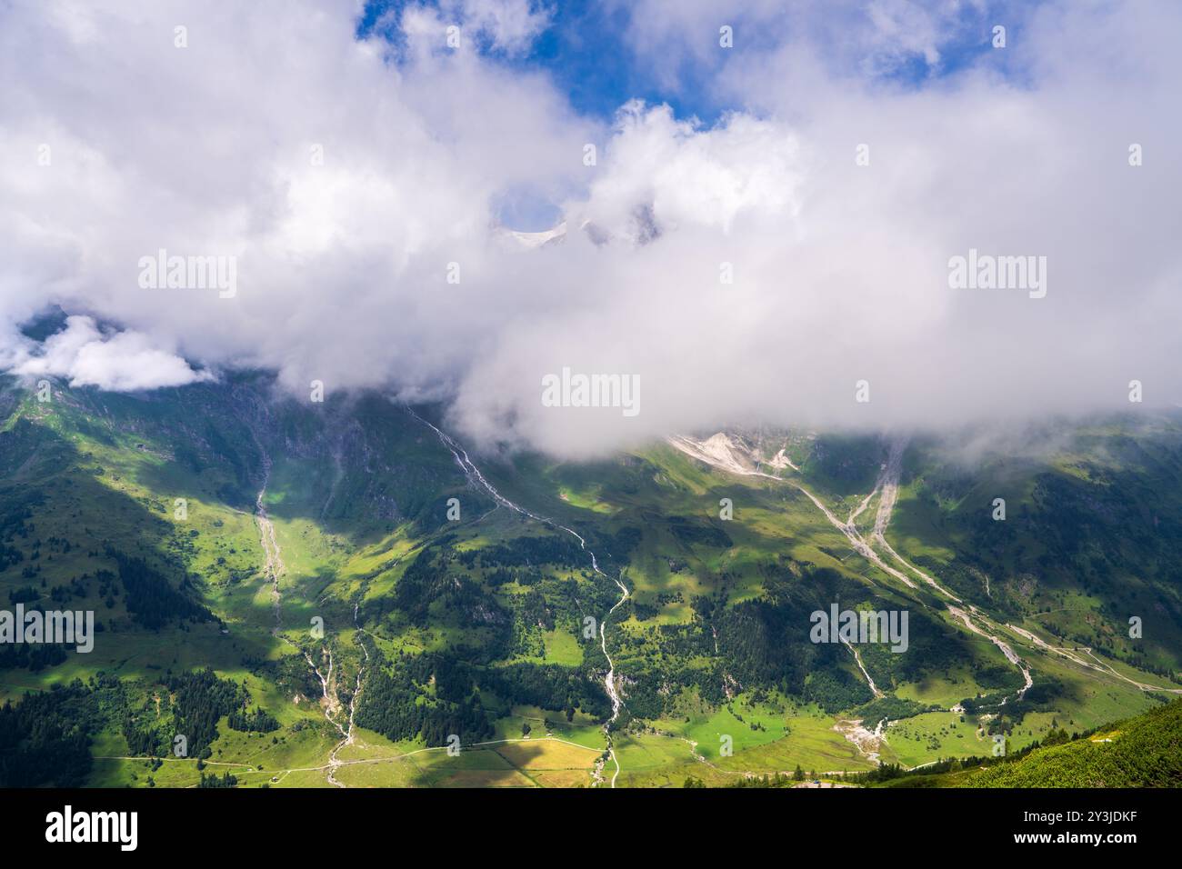 Majestic mountain peaks covered with clouds. Mountain rivers ...
