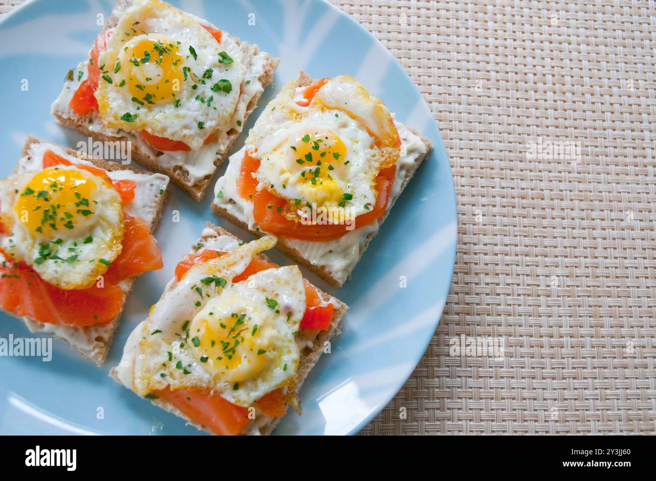 Spanish tapa: fried quail eggs with smoked salmon Stock Photo - Alamy