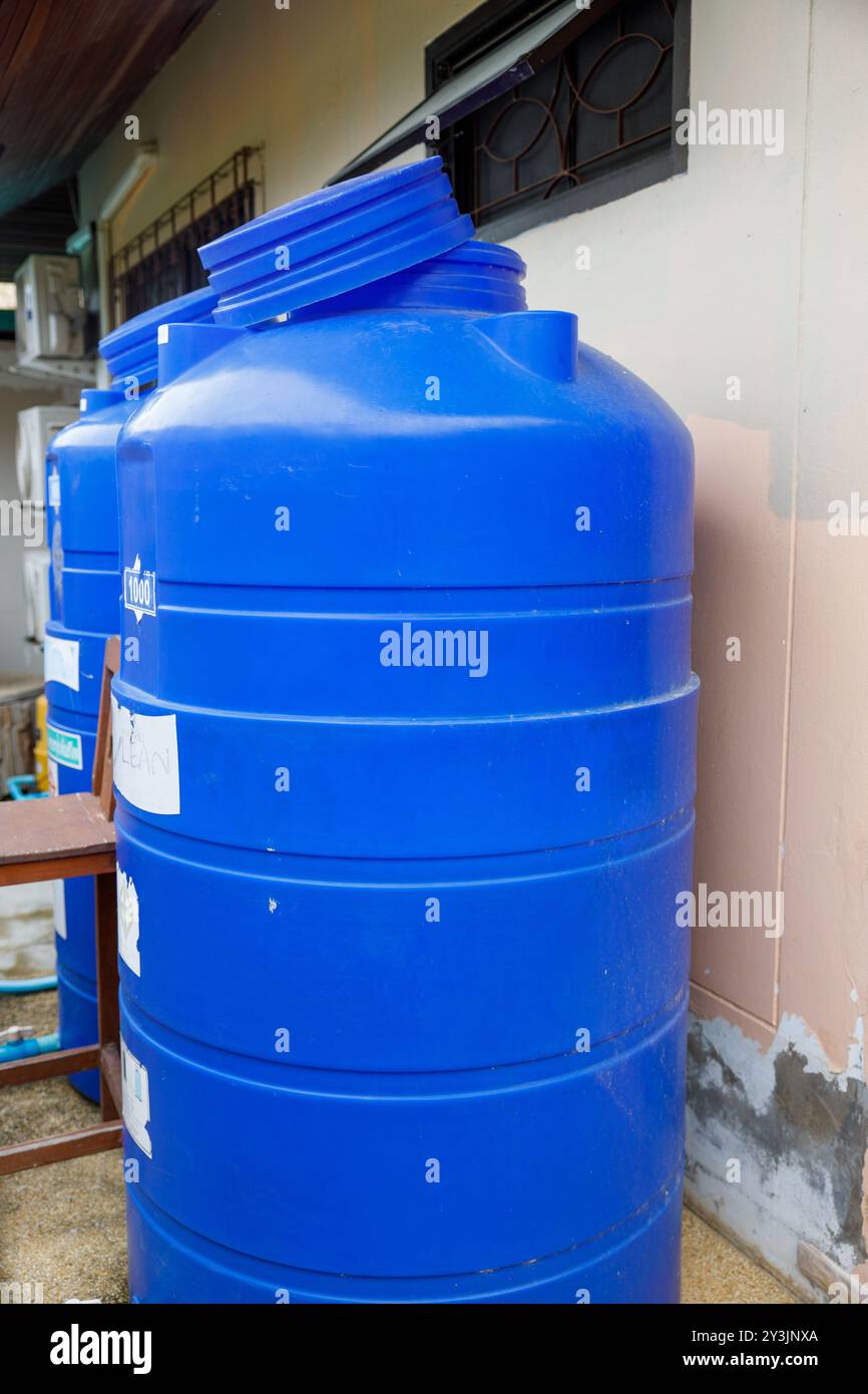 A large blue water storage tank commonly used in Thailand for ...