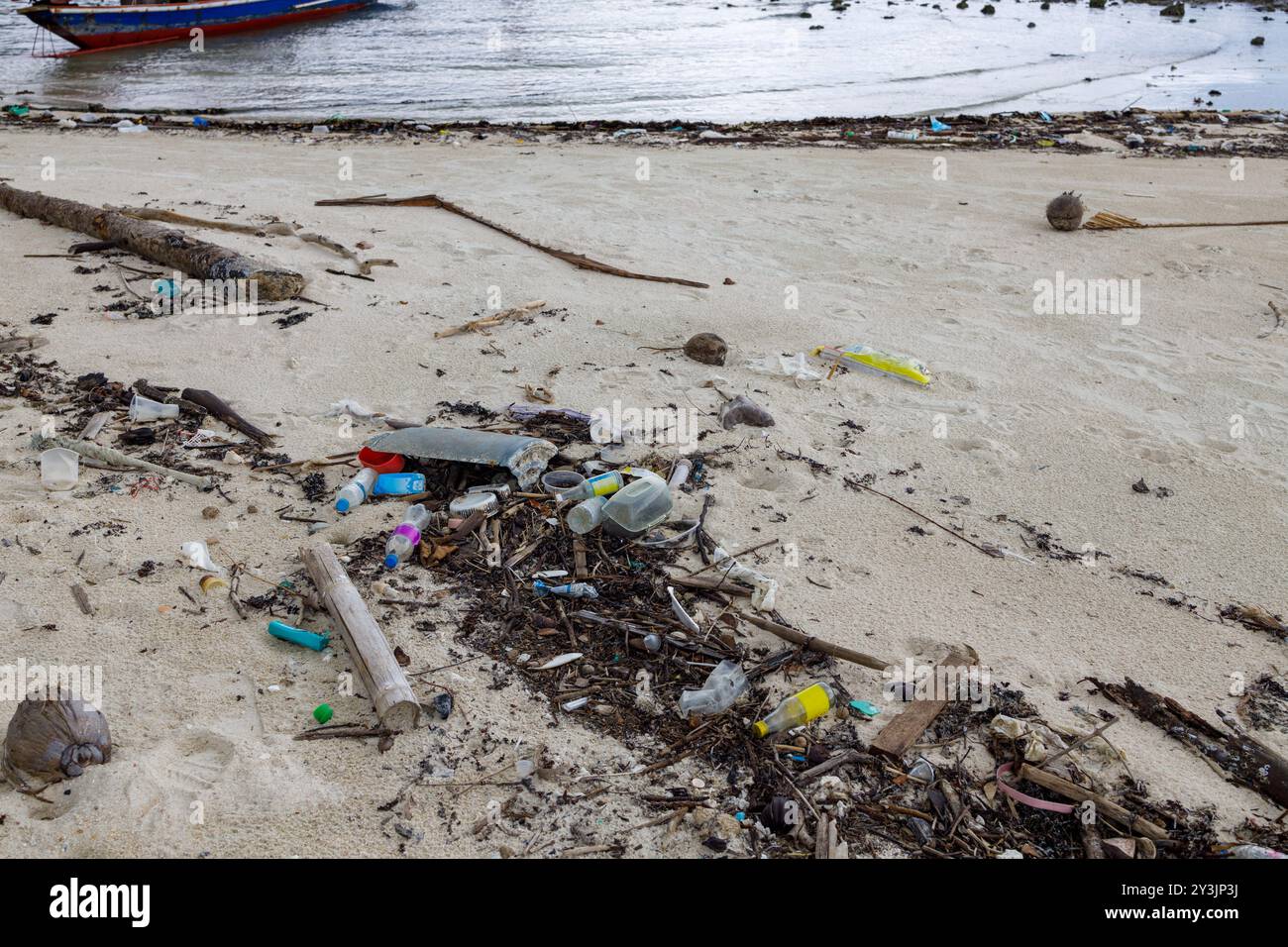 A polluted beach on Ko Samui, Thailand, littered with plastic bottles ...