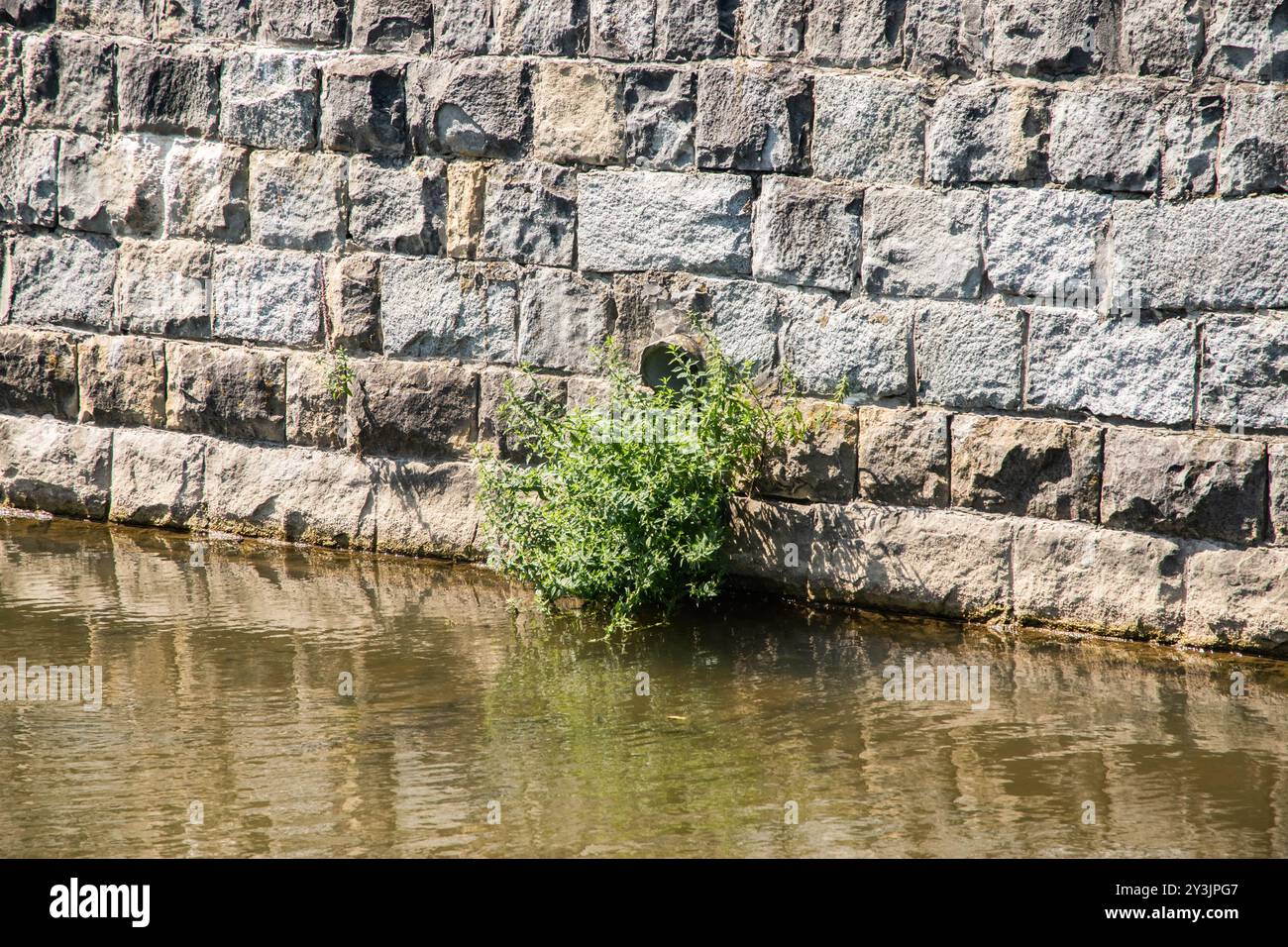 Old stone wall with water reflection in the canal Stock Photo - Alamy