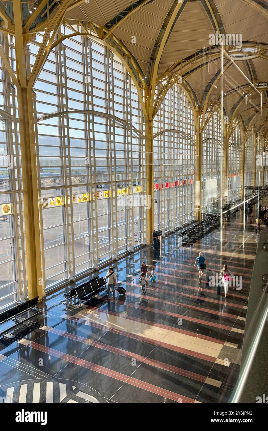 A large, open space with a lot of people walking around. The people are ...