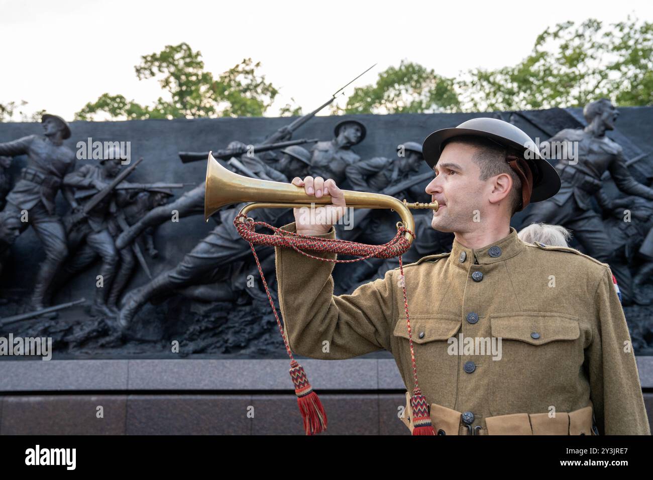 Washington, USA. 13th Sep, 2024. A man in a WWI era military uniform blows a horn at the ...