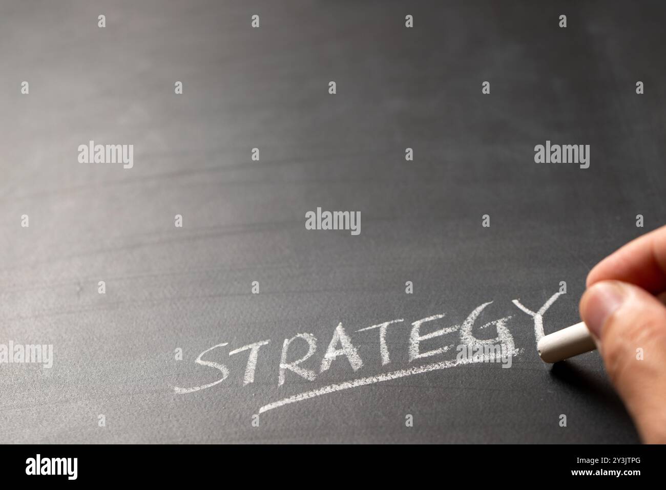 Hand writing strategy word on blackboard Stock Photo - Alamy