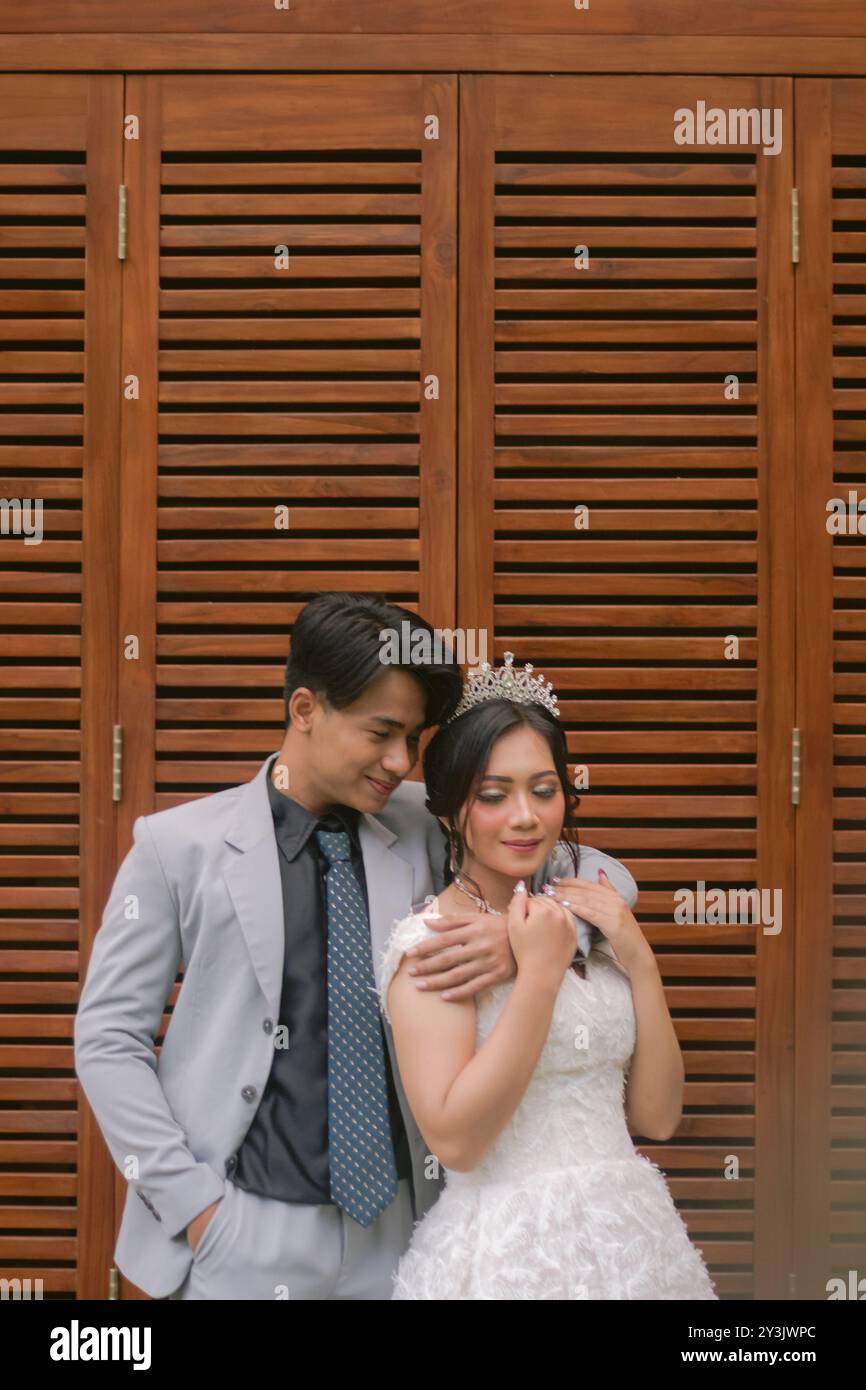 a pair of men and women in elegant poses standing with men arms ...