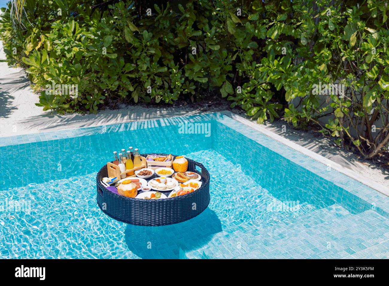A floating breakfast tray with various dishes and drinks is located in ...
