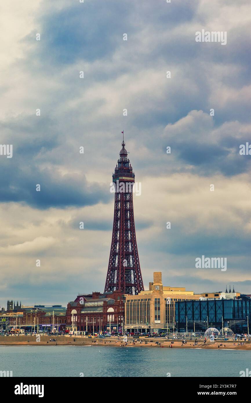 A tall iron tower stands prominently against a cloudy sky, overlooking ...